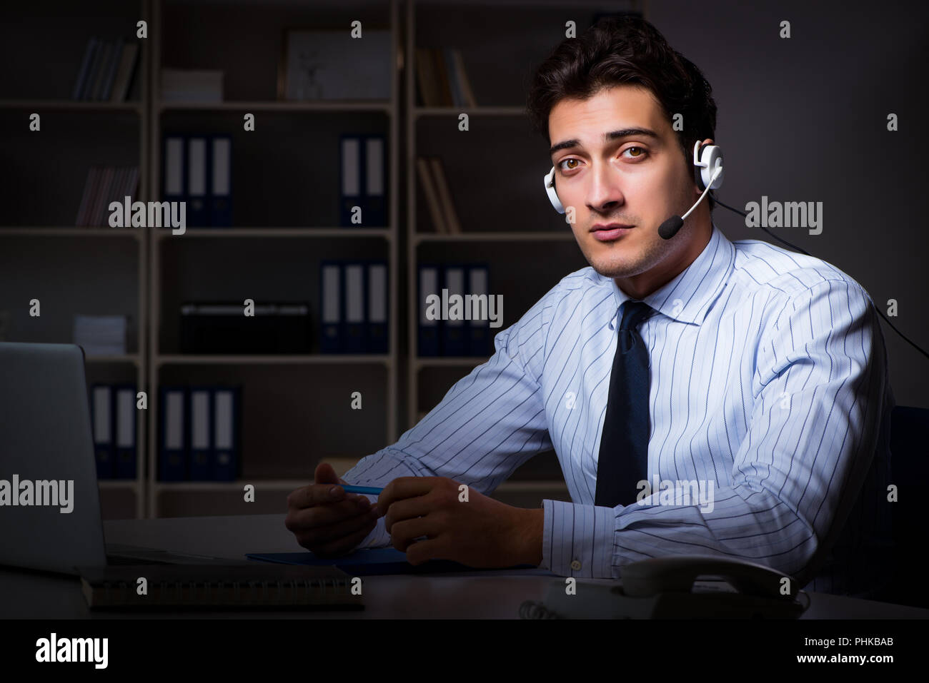 Tired and exhausted helpdesk operator during night shift Stock Photo ...