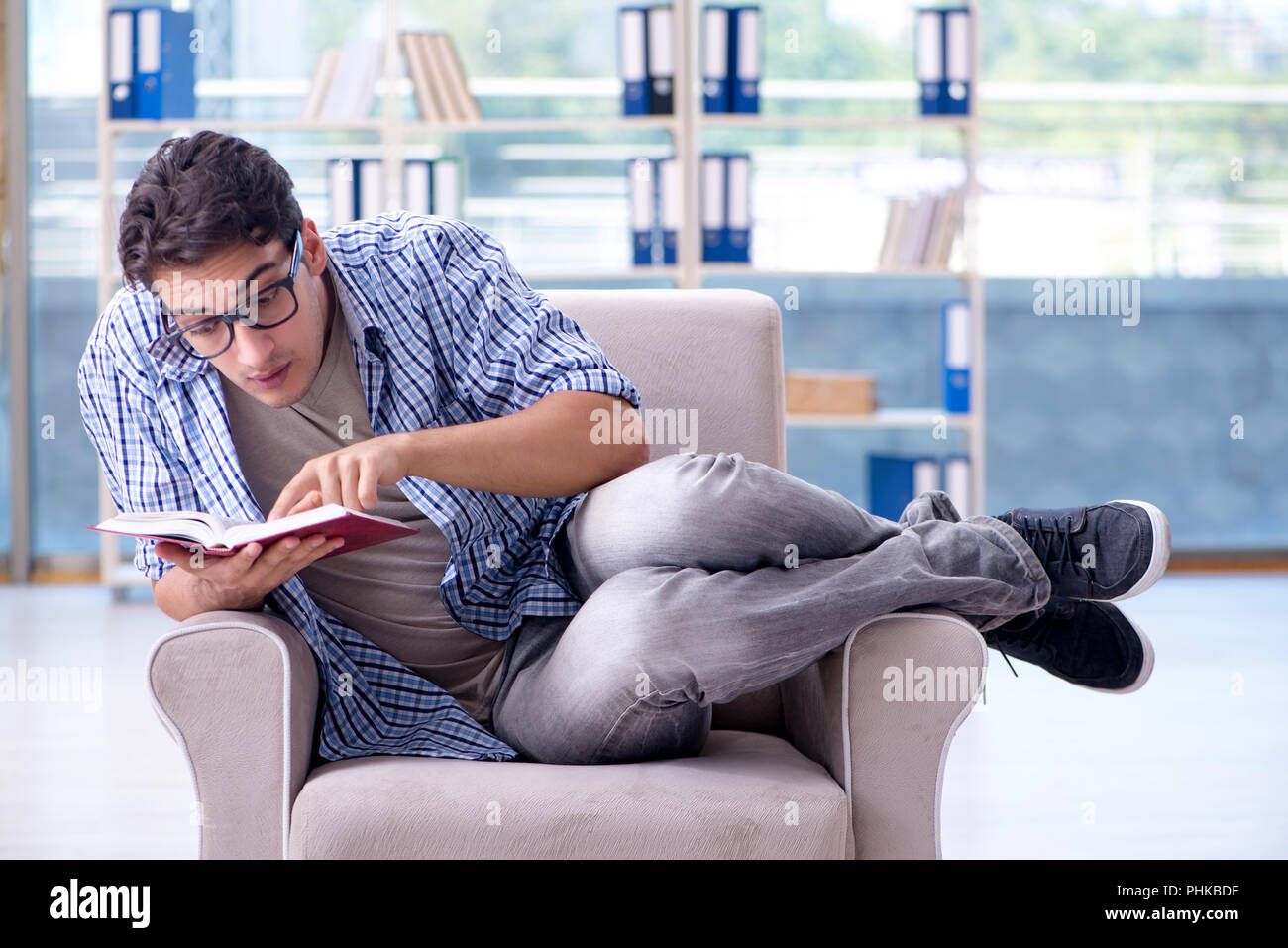 Student reading books and preparing for exams in library Stock Photo ...
