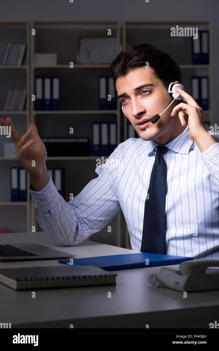 Tired and exhausted helpdesk operator during night shift Stock Photo ...