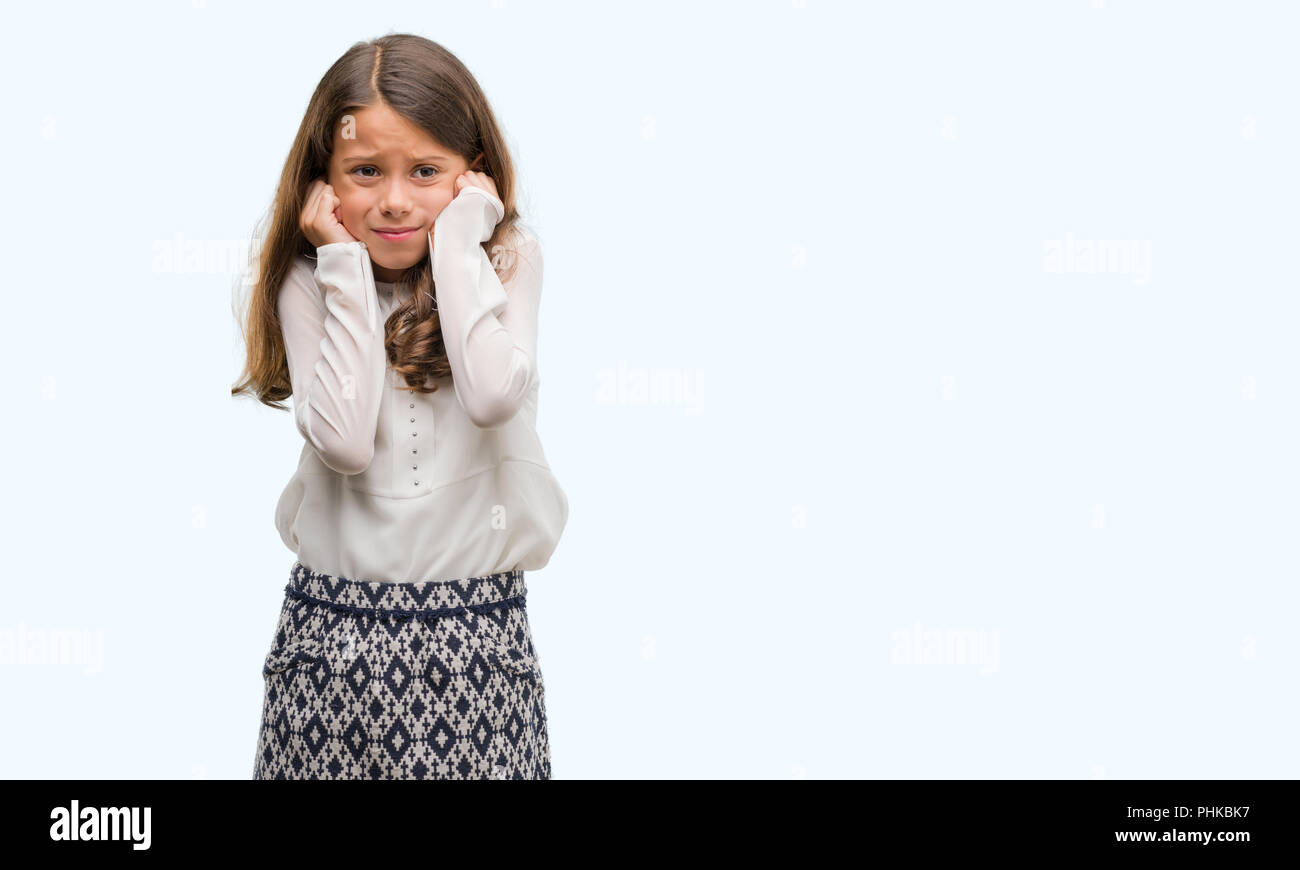 Brunette hispanic girl covering ears with fingers with annoyed ...