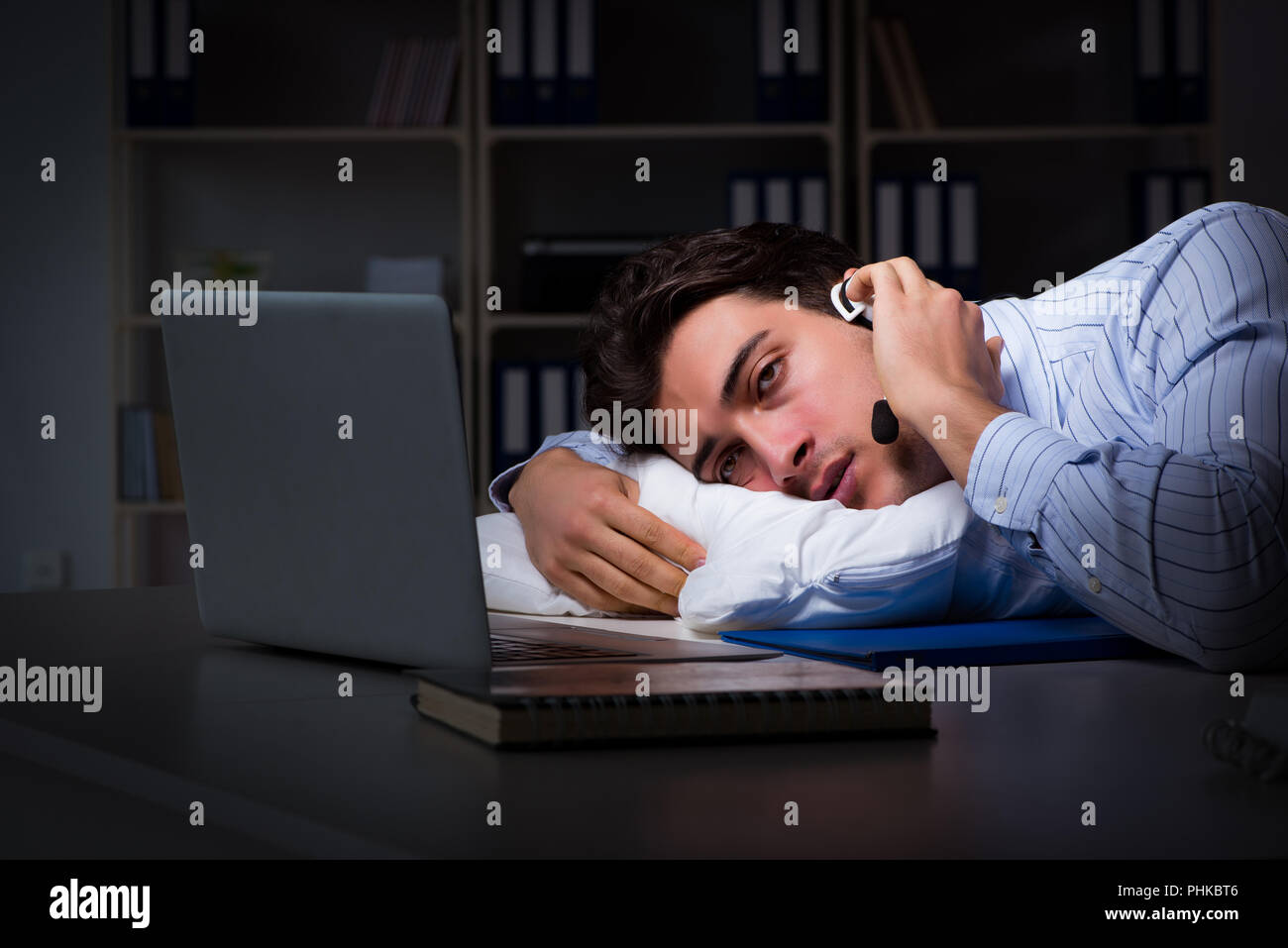 Tired and exhausted helpdesk operator during night shift Stock Photo ...