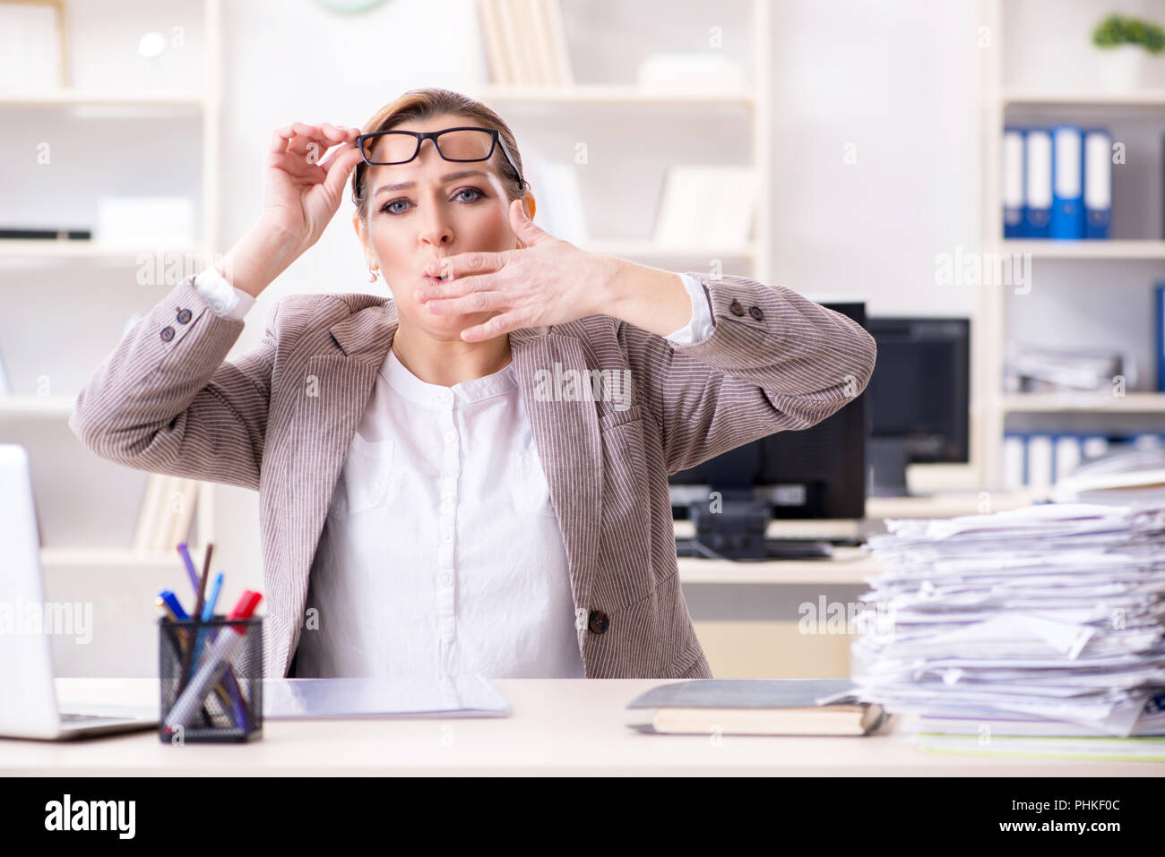 Businesswoman surprised stack folders desk hi-res stock photography and ...