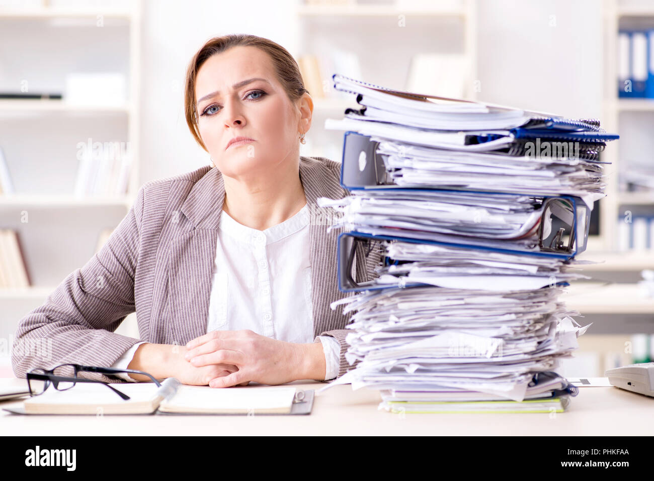 Businesswoman very busy with ongoing paperwork Stock Photo - Alamy