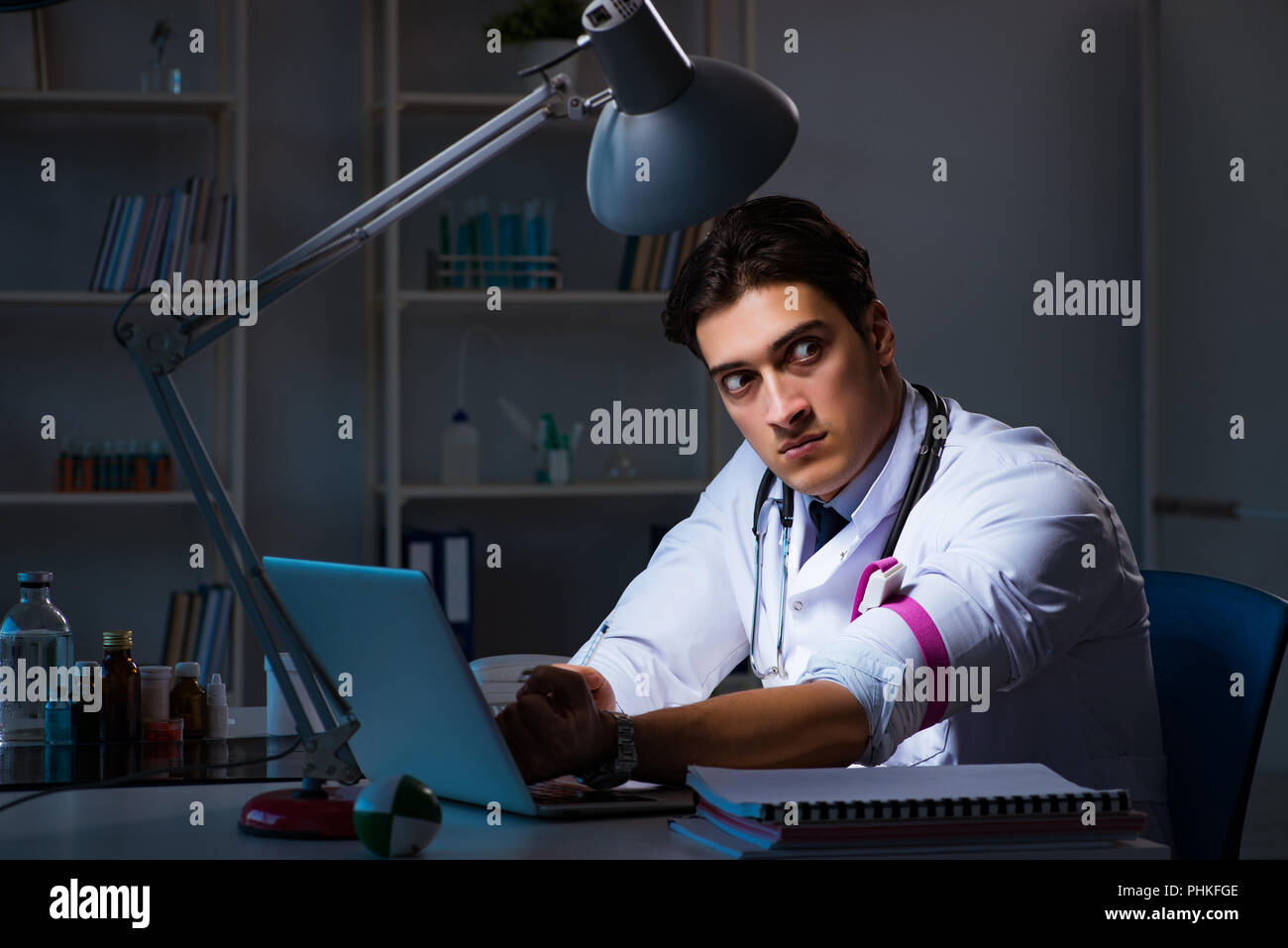 Doctor drug addict staying late on hospital Stock Photo - Alamy