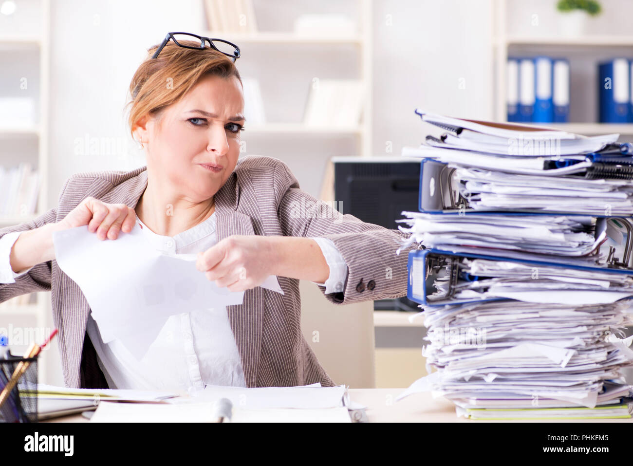 Businesswoman very busy with ongoing paperwork Stock Photo - Alamy
