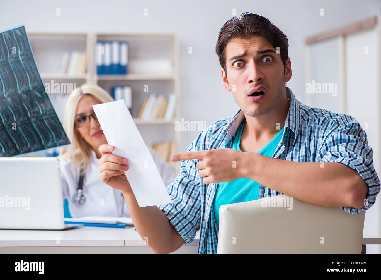 Male patient angry at expensive healthcare bill Stock Photo - Alamy