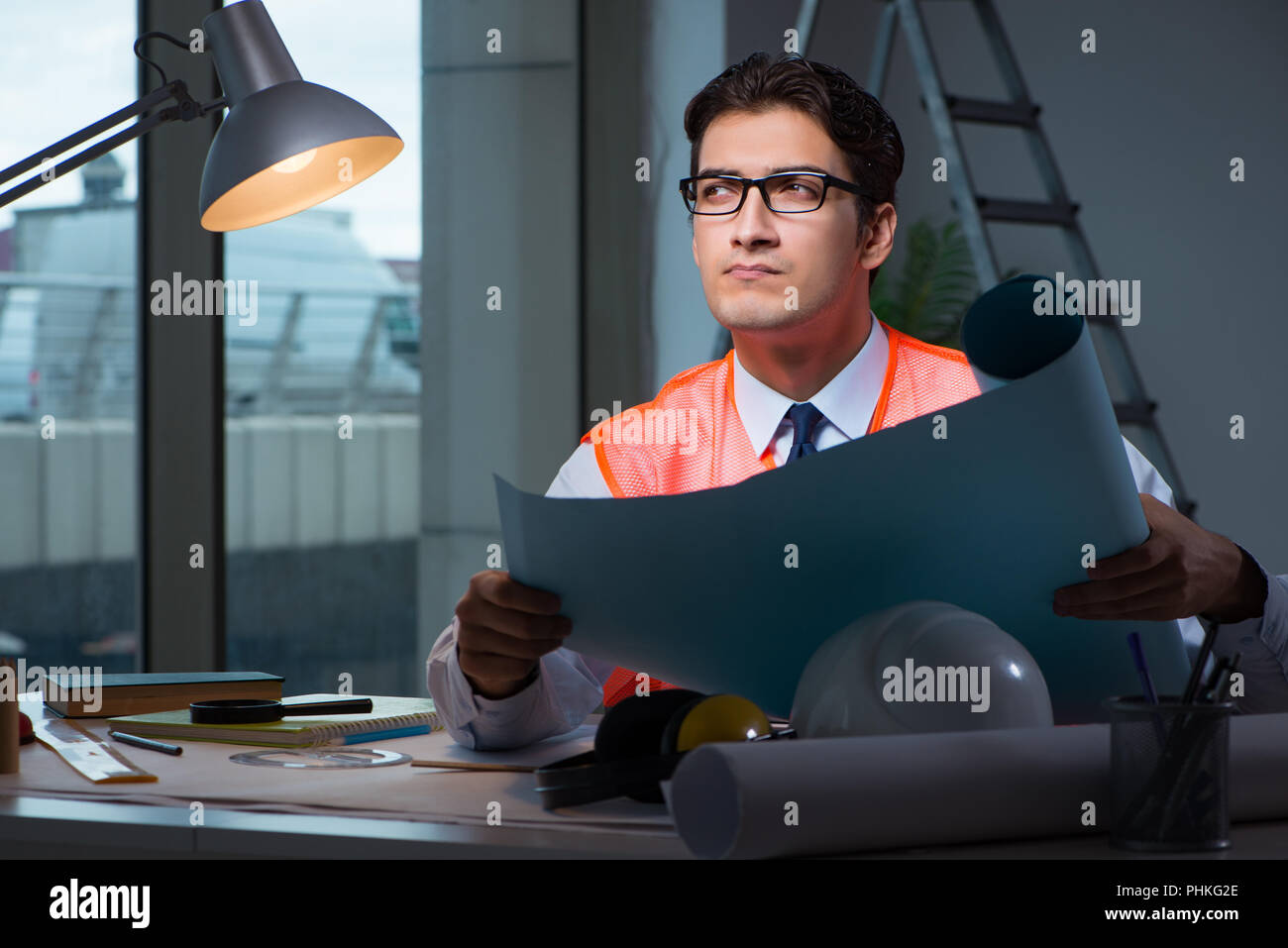 Construction architect working on drawings late at night Stock Photo ...