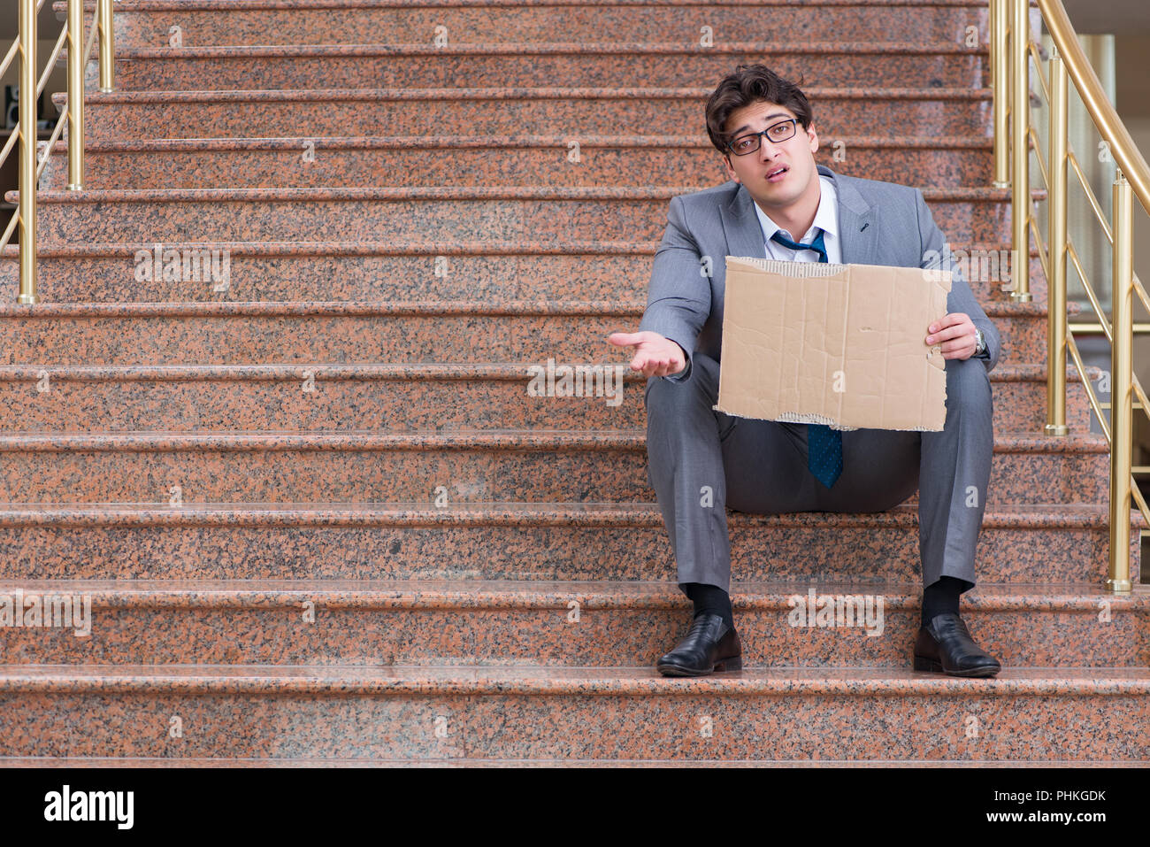 Desperate businessman begging on the street Stock Photo - Alamy