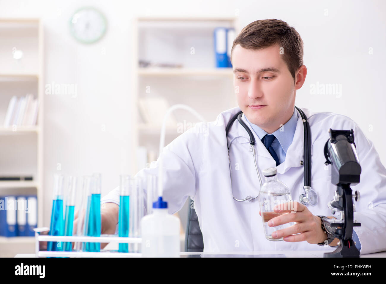 Male doctor looking at lab results in hospital Stock Photo - Alamy
