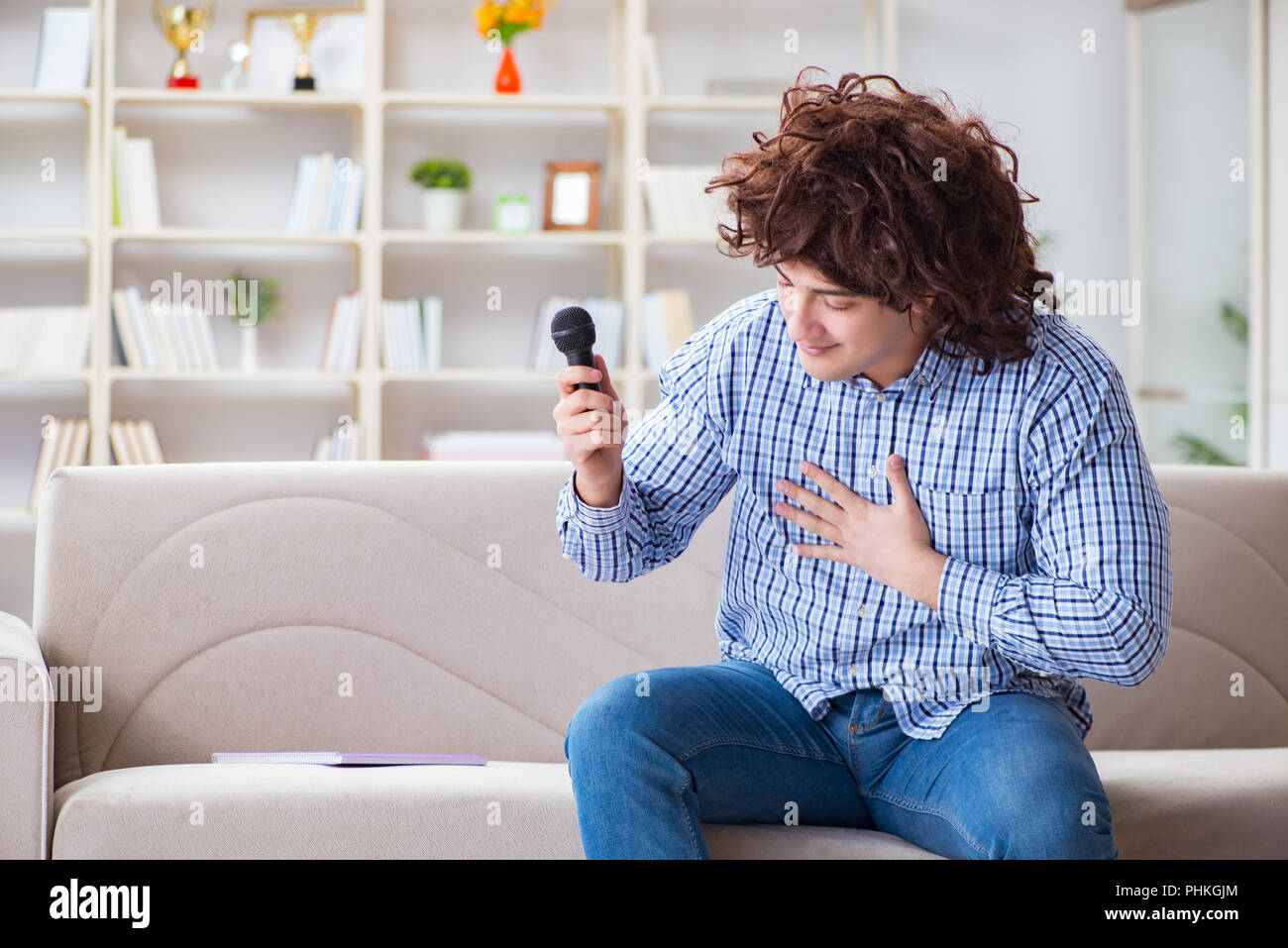 Funny man singing songs in karaoke at home Stock Photo - Alamy