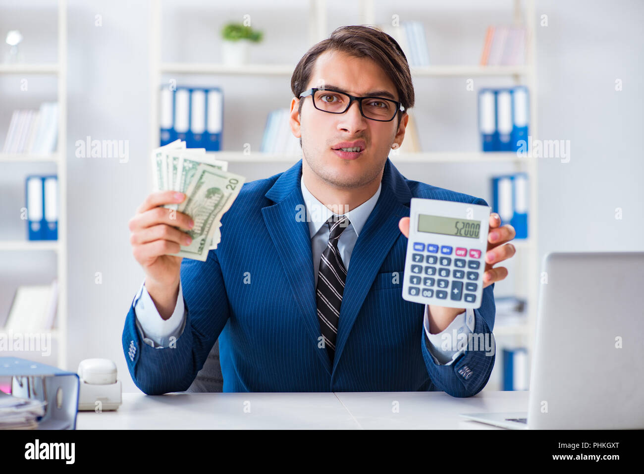 Accountant calculating dollars with calculator in office Stock Photo ...
