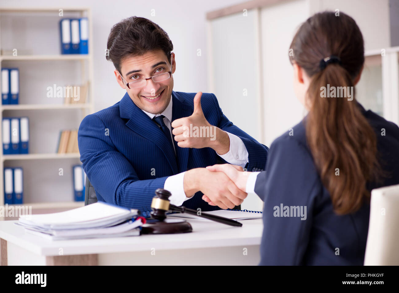 Lawyer talking to his client in office Stock Photo - Alamy