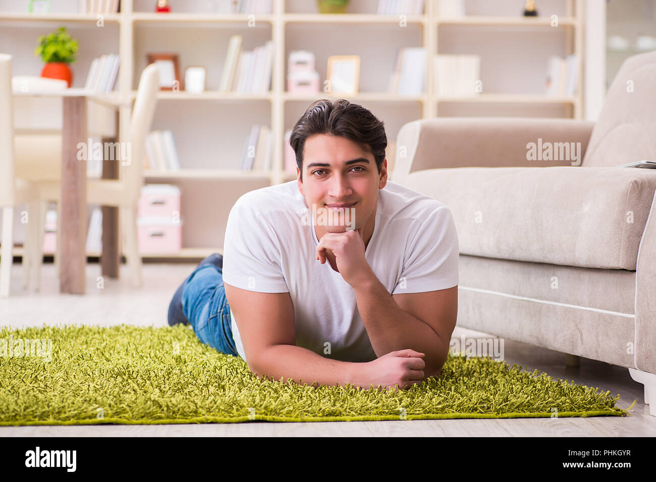 Young happy handsome man on carpet floor Stock Photo - Alamy