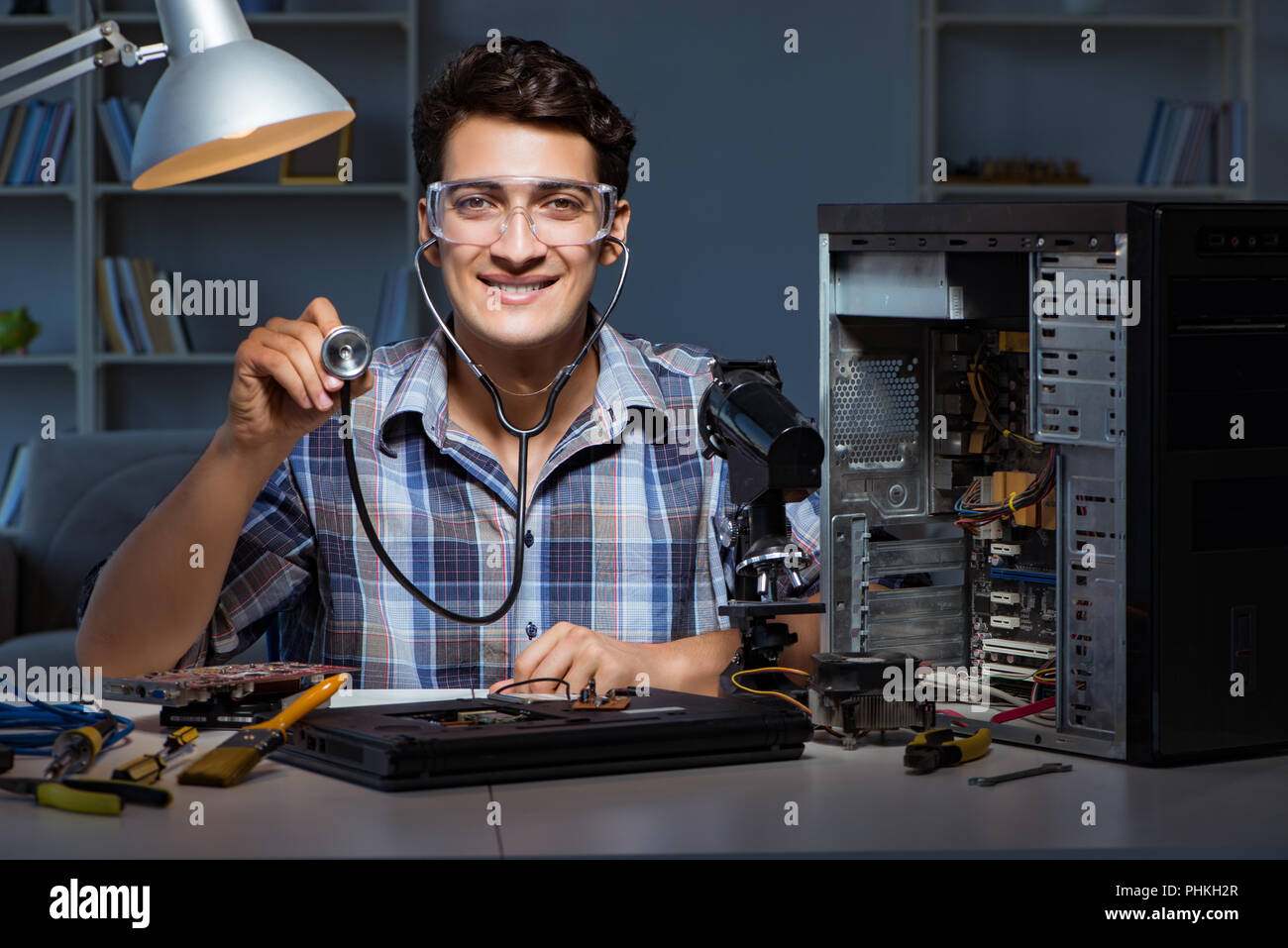 Computer repair concept with man inspecting with stethoscope Stock ...
