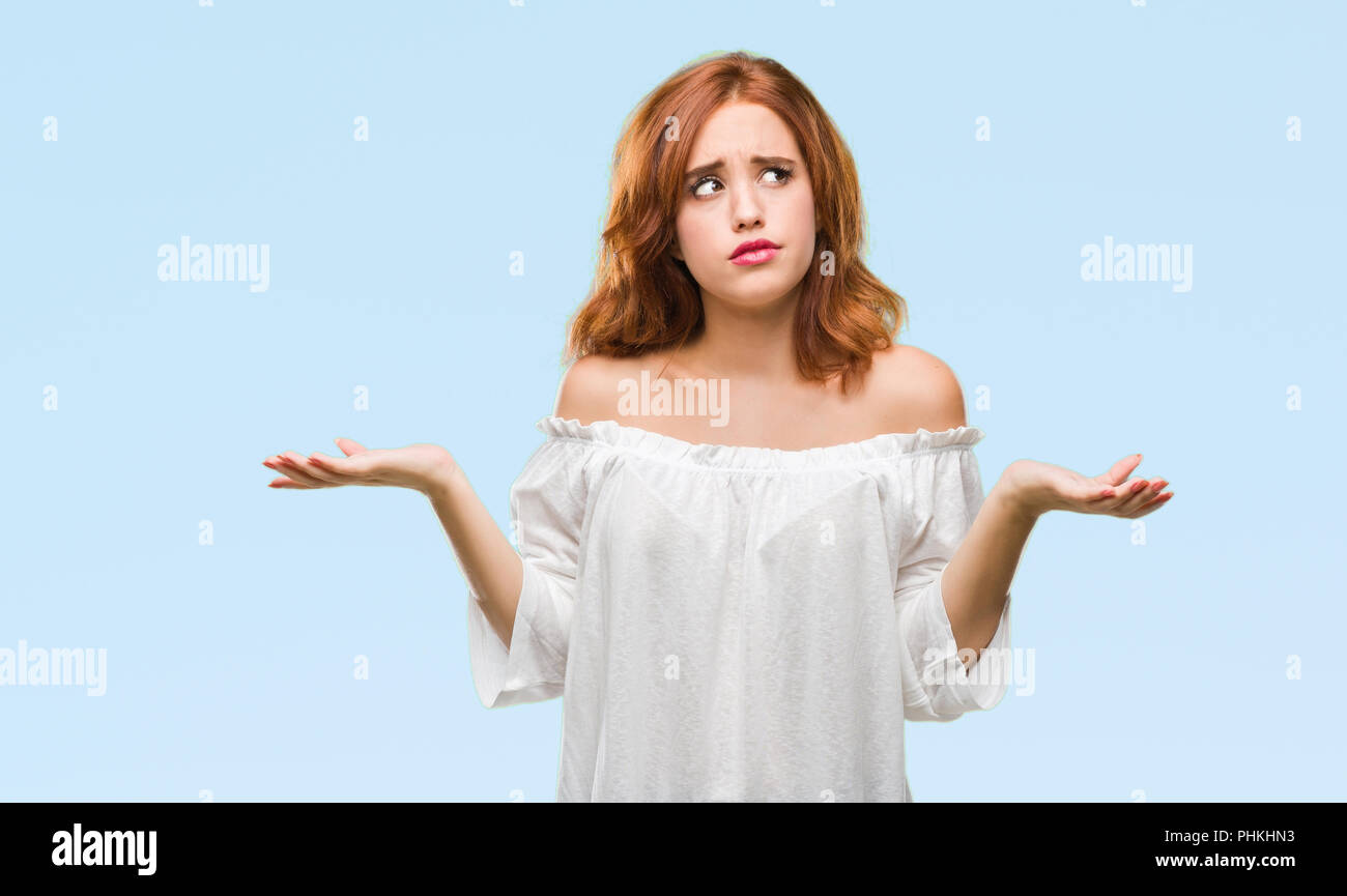 Young beautiful woman over isolated background clueless and confused ...