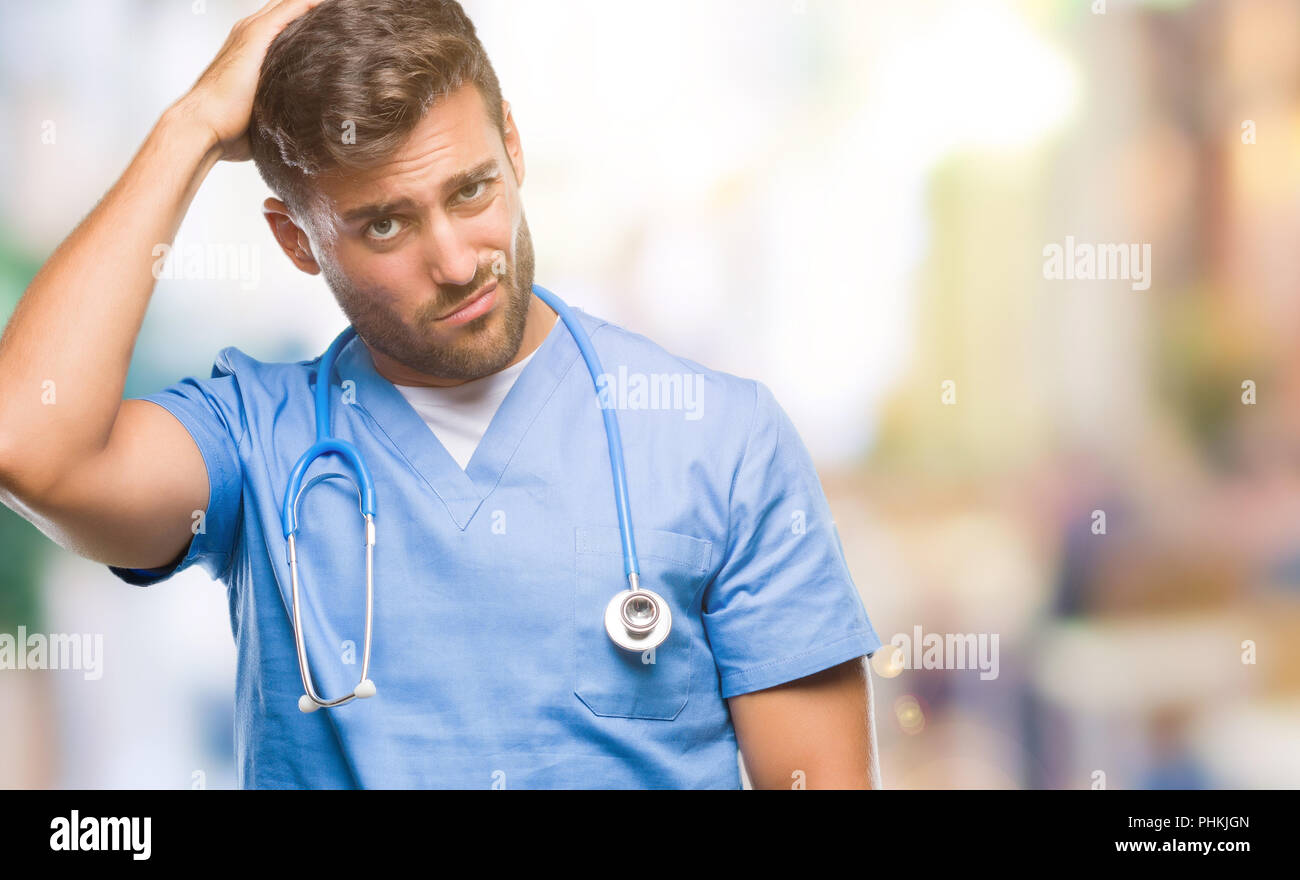 Young handsome doctor surgeon man over isolated background confuse and ...