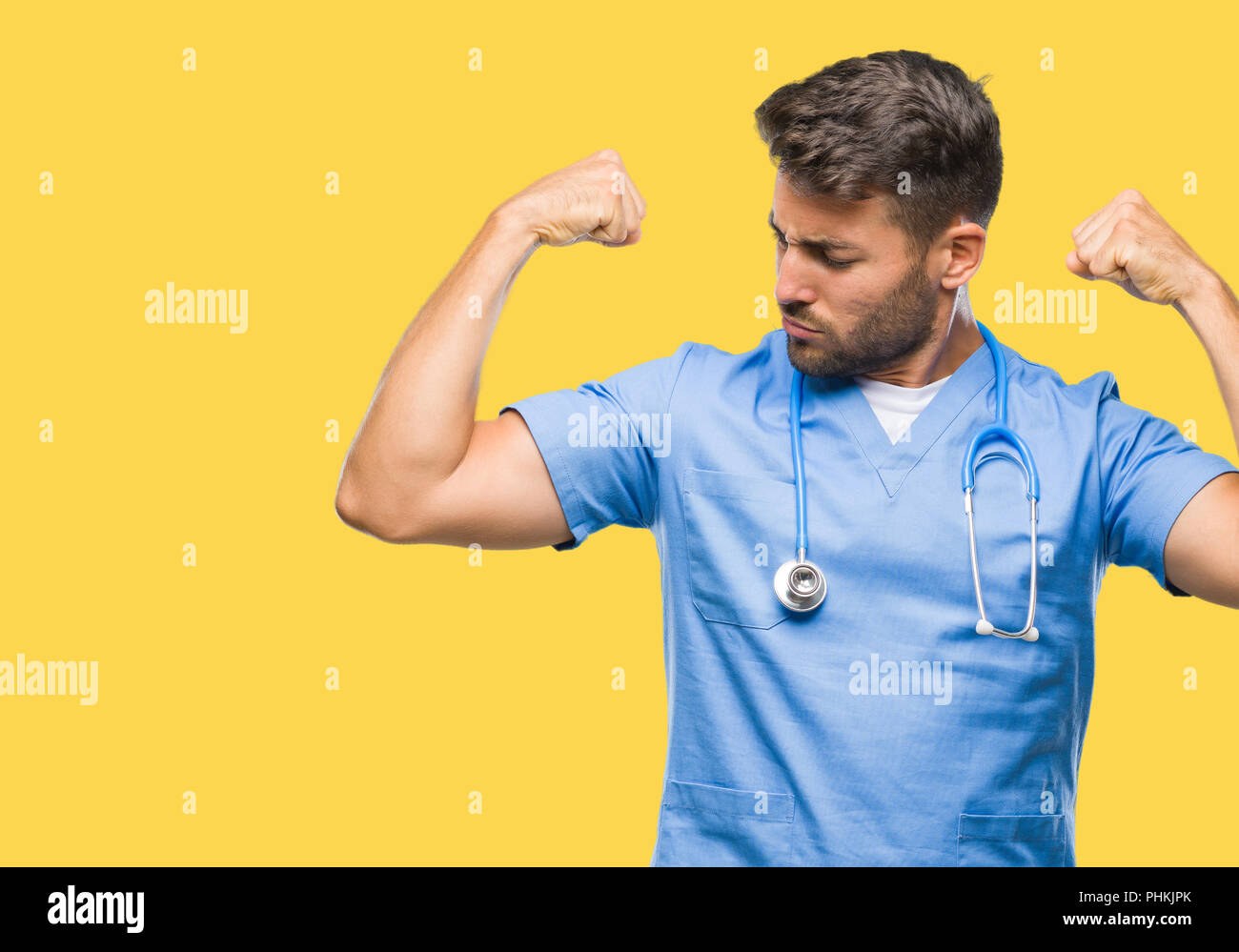 Young handsome doctor surgeon man over isolated background showing arms ...