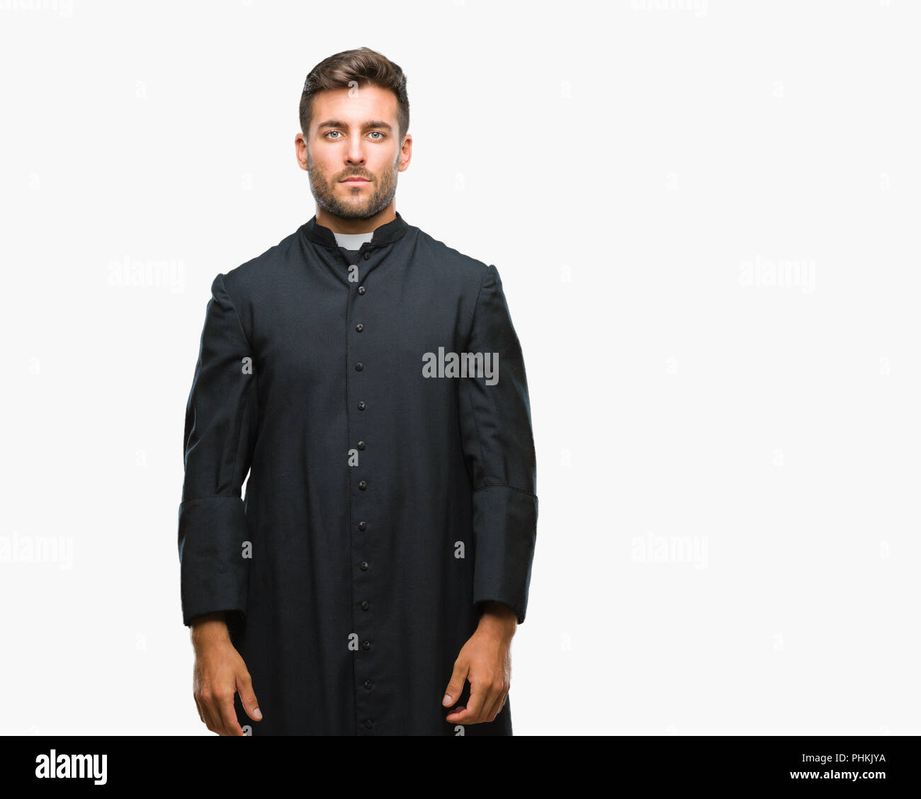 Young catholic christian priest man over isolated background with ...