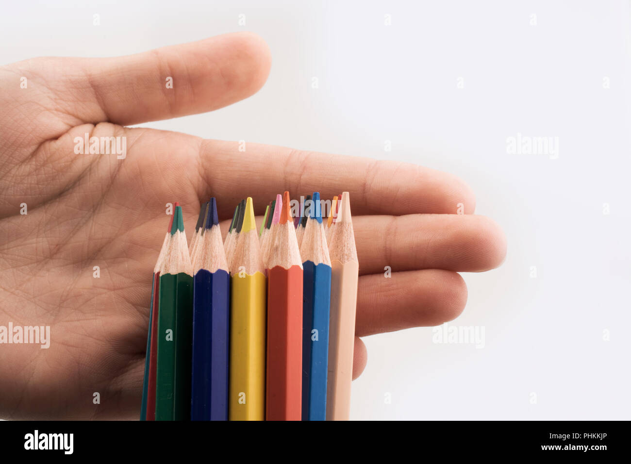 Hand holdin color pencils on a white background Stock Photo - Alamy