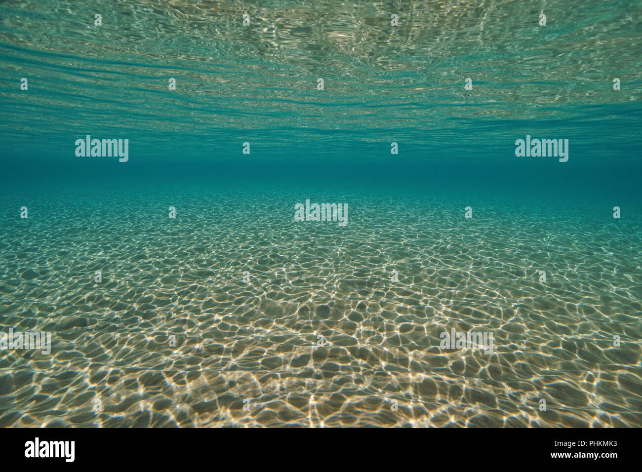 Underwater sand below water surface in the Mediterranean sea, natural ...