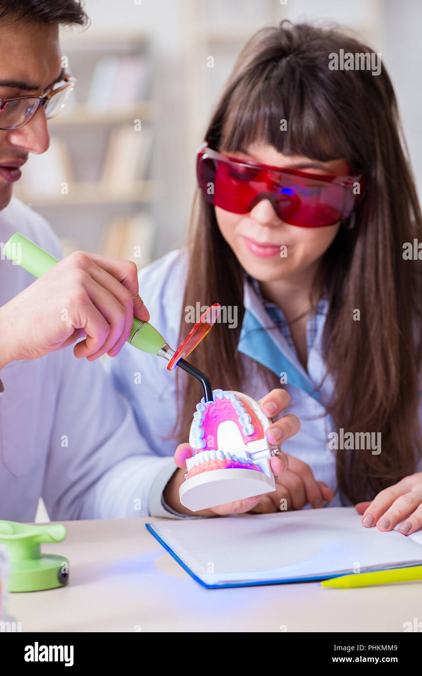 Doctor explaining to assistant how to use ultraviolet gun Stock Photo ...