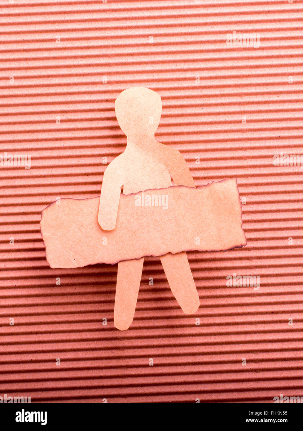 Paper man shape holding burnt note paper in hand Stock Photo - Alamy