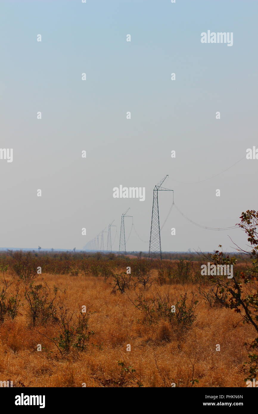 Row of power line towers standing in beautiful perspective in the ...