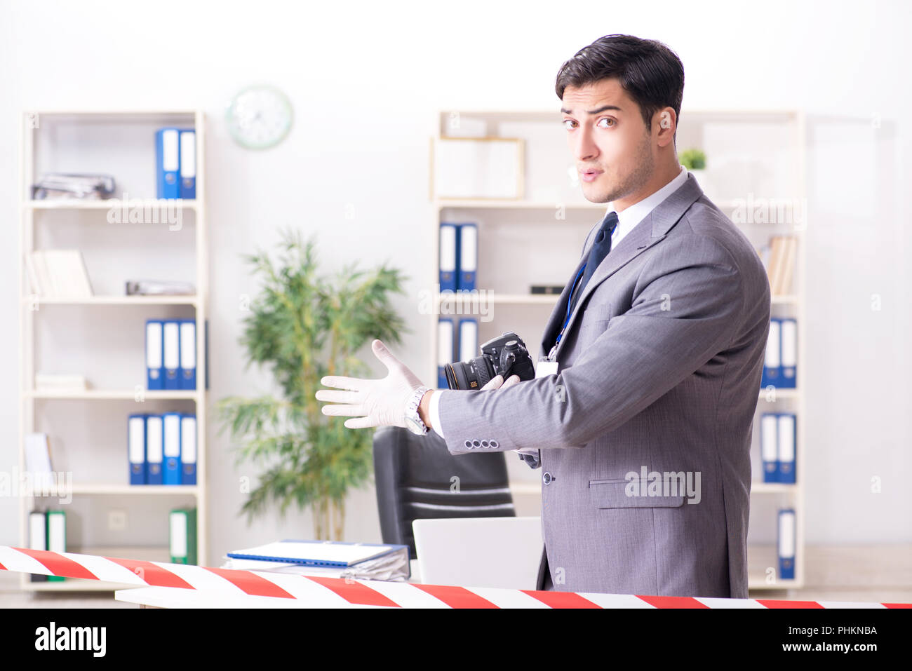 Forensics investigator at the scene of office crime Stock Photo - Alamy