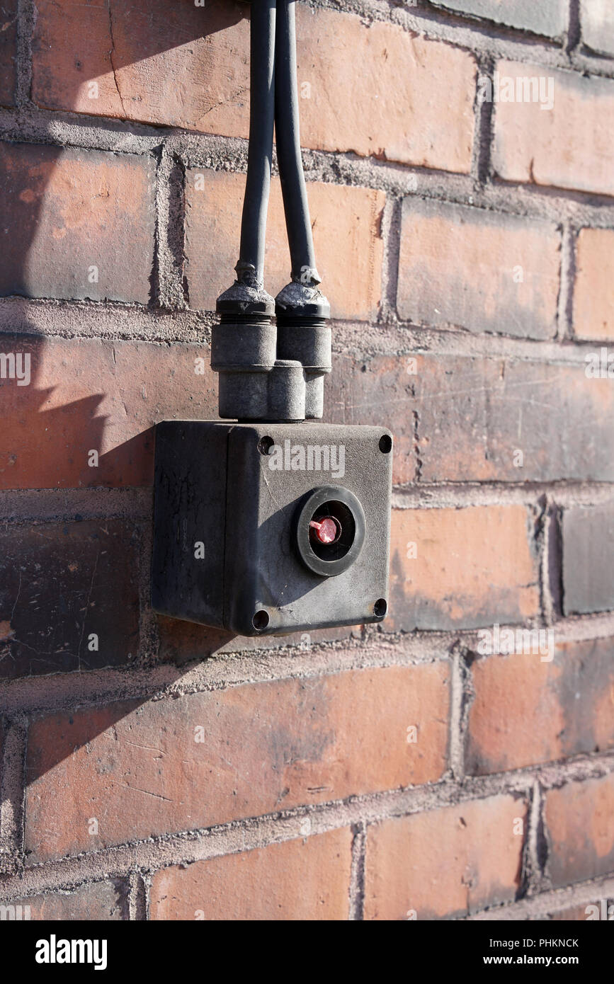 Old emergency stop switch on a house wall in the port of Magdeburg ...