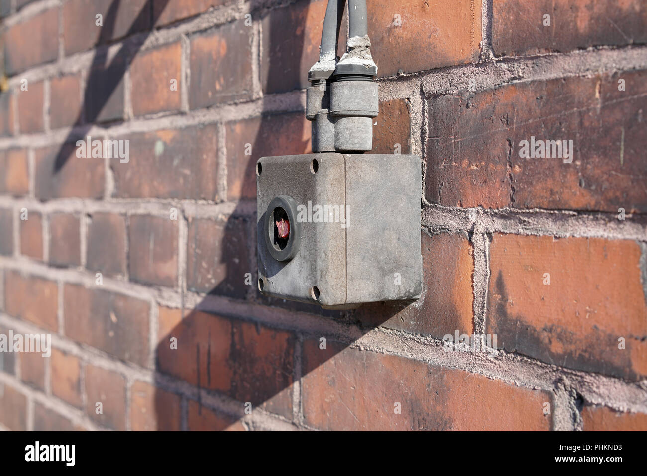 Old emergency stop switch on a house wall in the port of Magdeburg ...