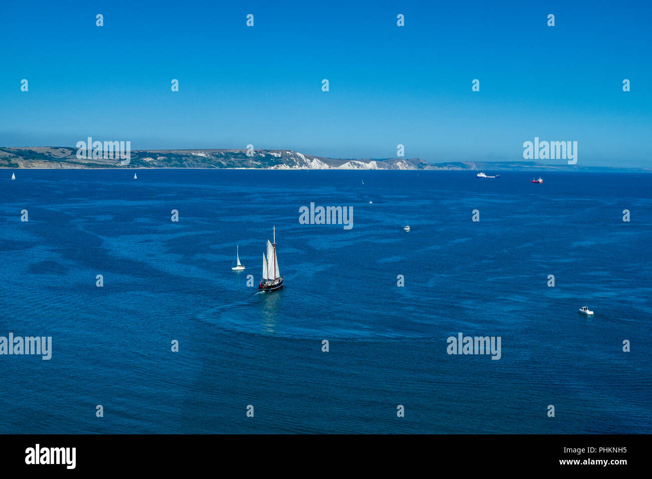 High shot of a tall ship cruising in the blue waters of Weymouth Bay by ...
