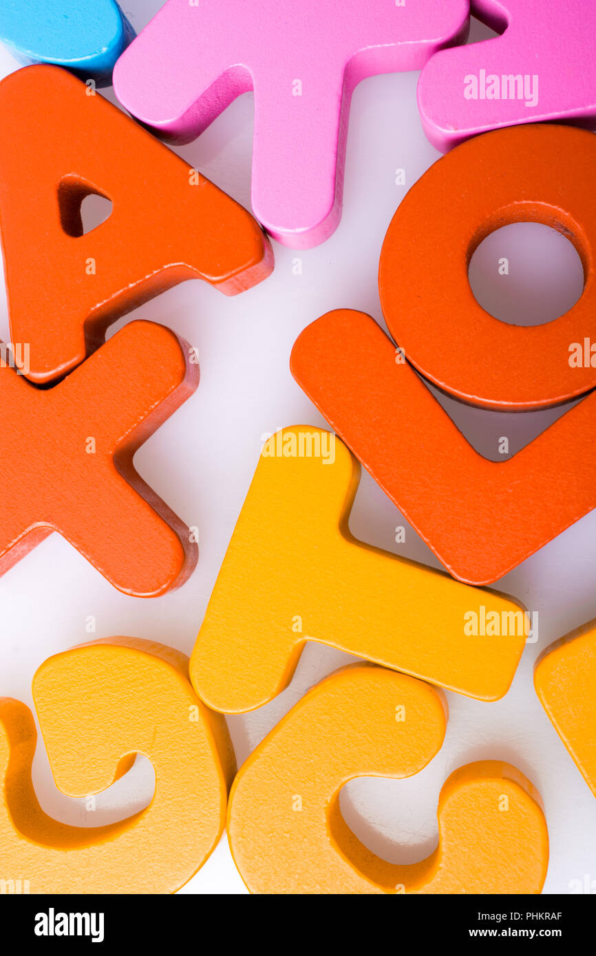 Colorful alphabet letter blocks scattered randomly on white background ...