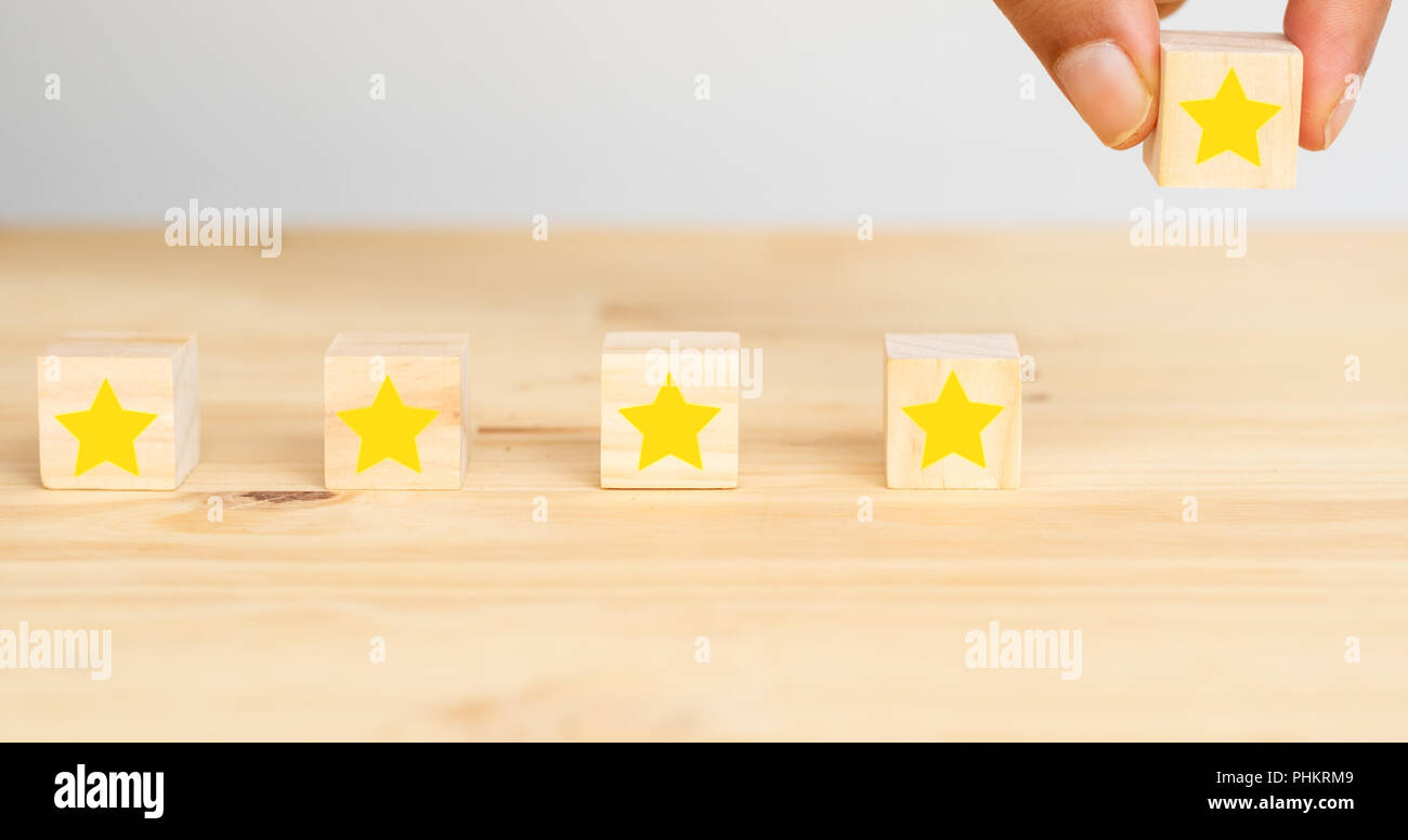 business successful concept, hand man try to put the the fifth star to ...