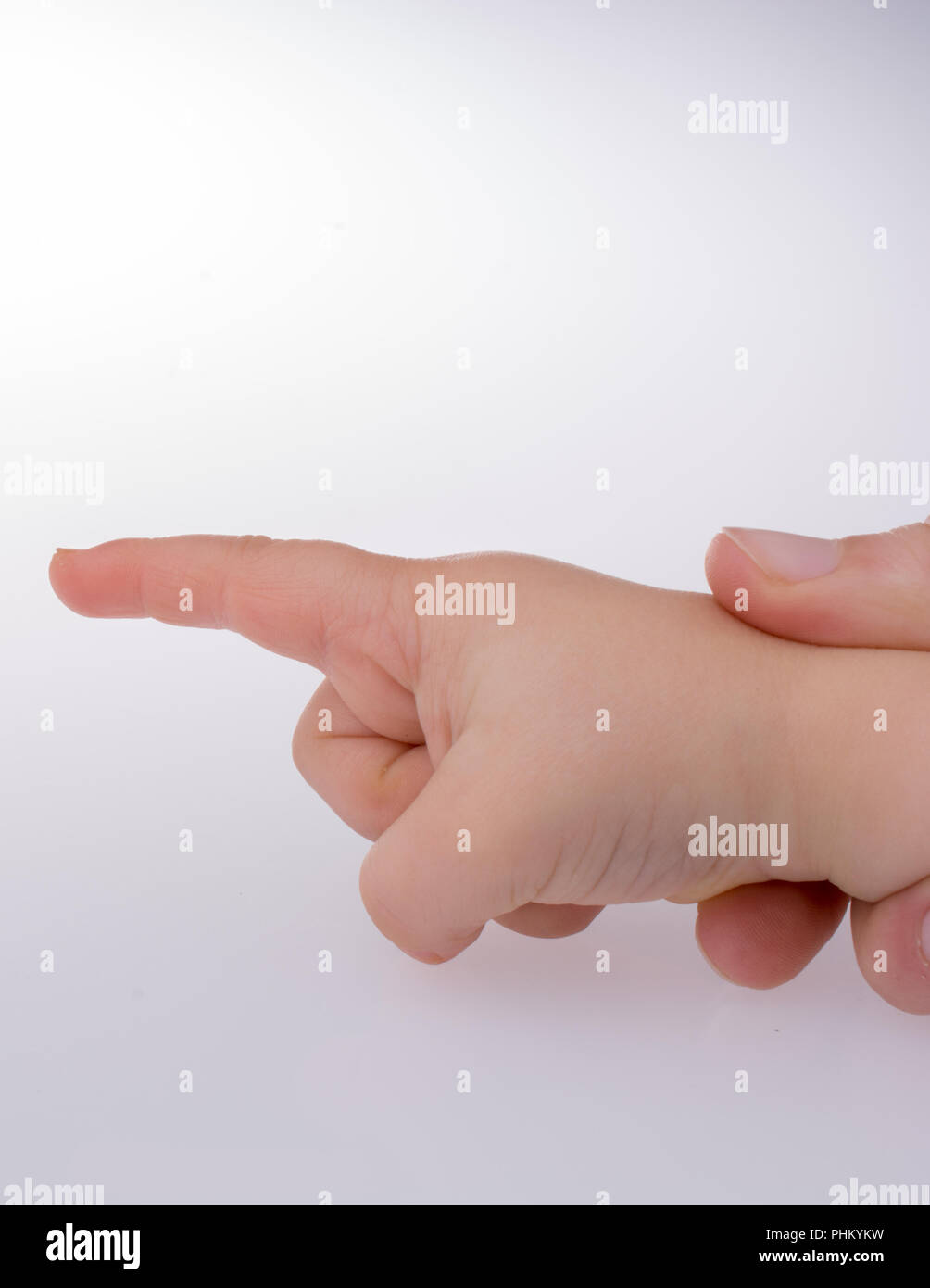 Little hand pointing at a model house on a white color background Stock ...