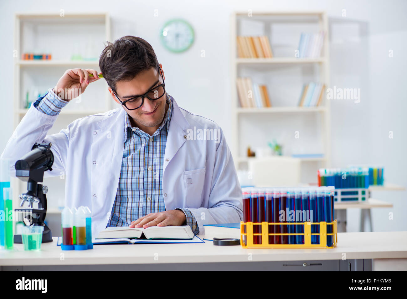 Young chemist student working in lab on chemicals Stock Photo - Alamy