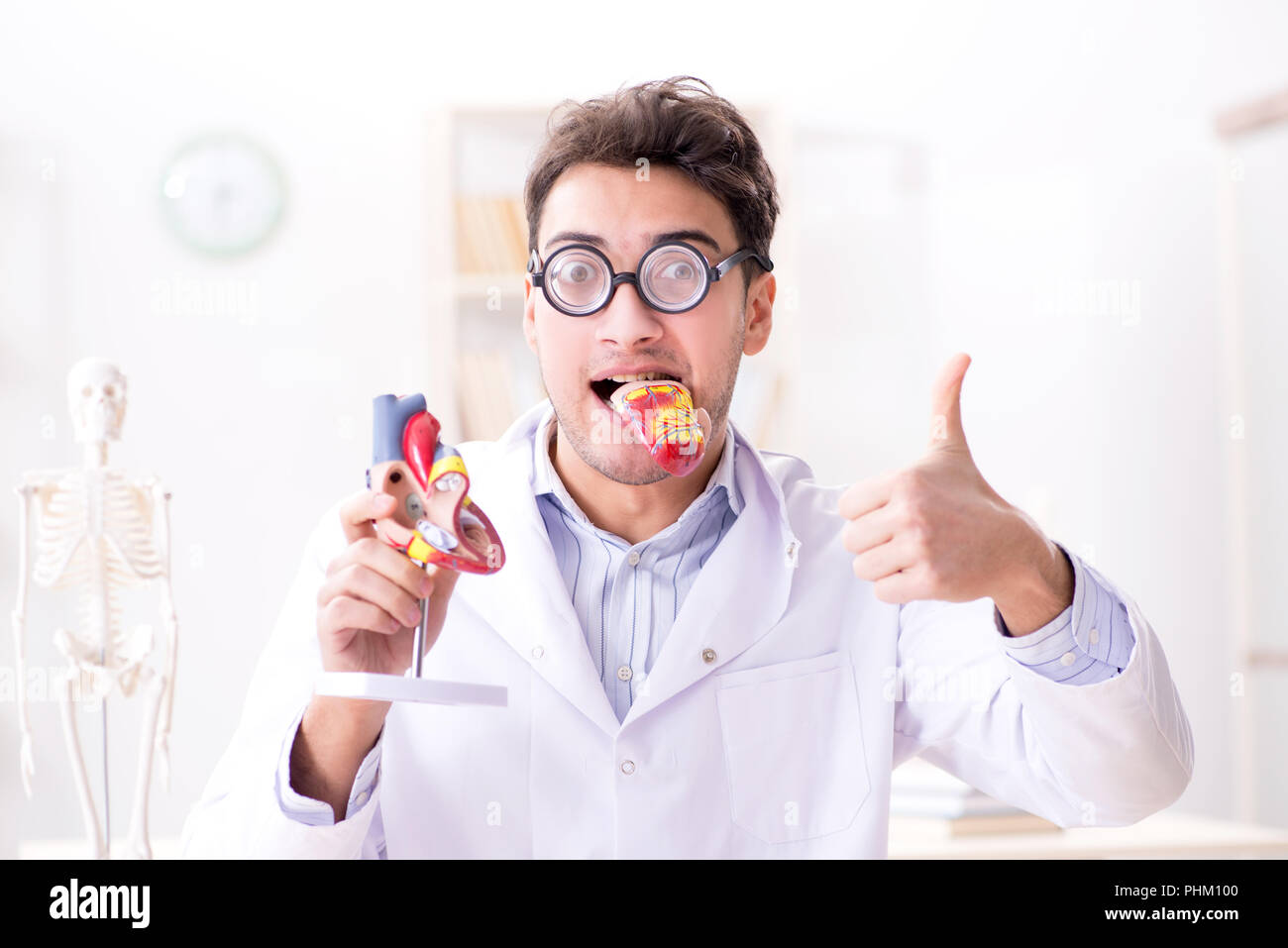 Crazy doctor with heart model Stock Photo - Alamy