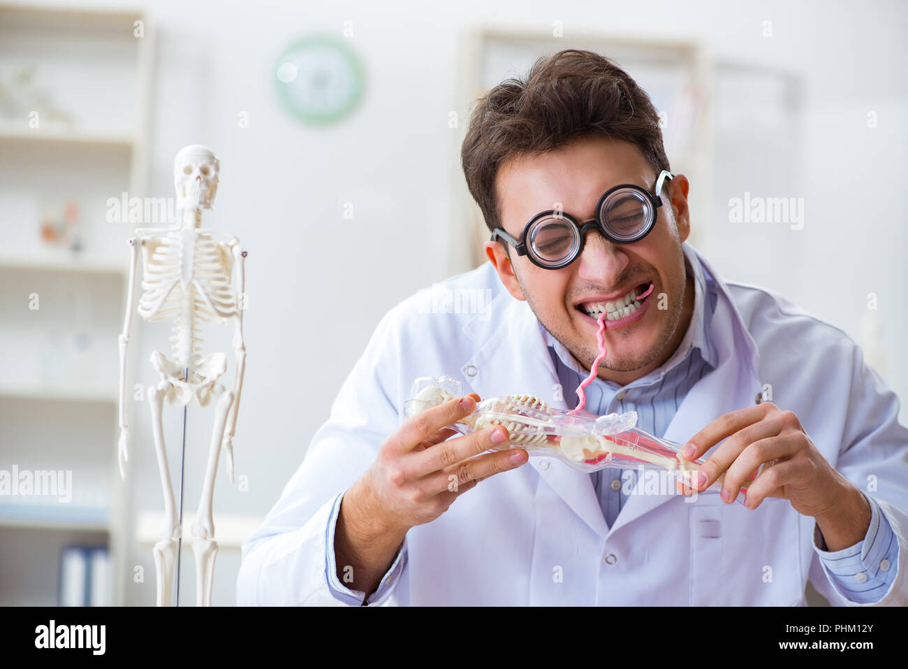 Crazy doctor studying human skeleton Stock Photo - Alamy