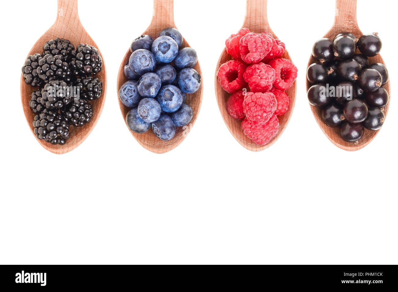 blackberry blueberry raspberry black currant in wooden spoon isolated ...