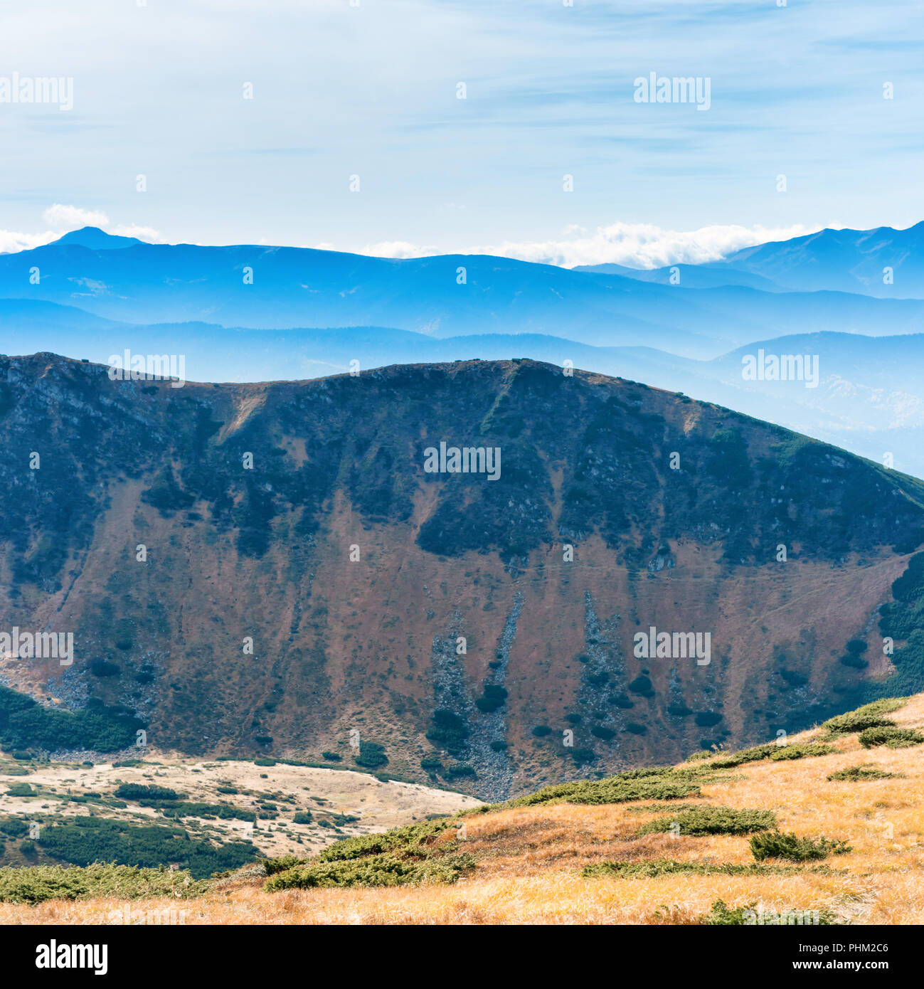 Mountains landscape with field of grass Stock Photo - Alamy