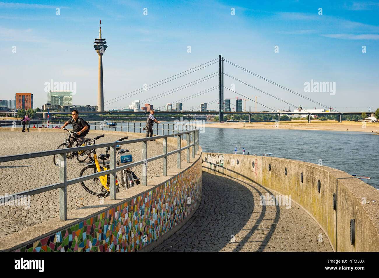View of the Rhine Tower and Rheinkniebrücke bridge over the river Rhine ...
