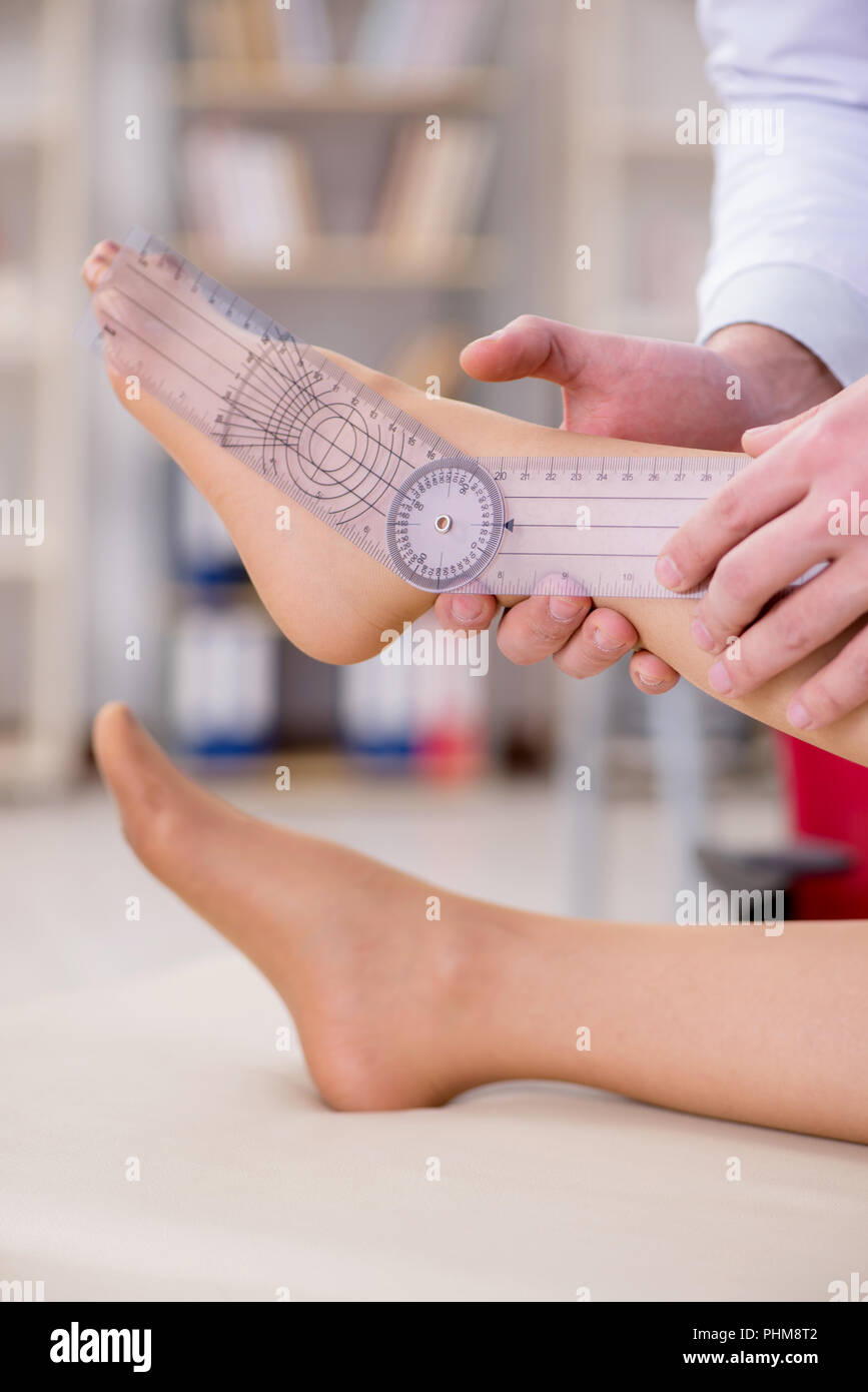 Doctor checking patients joint flexibility Stock Photo - Alamy