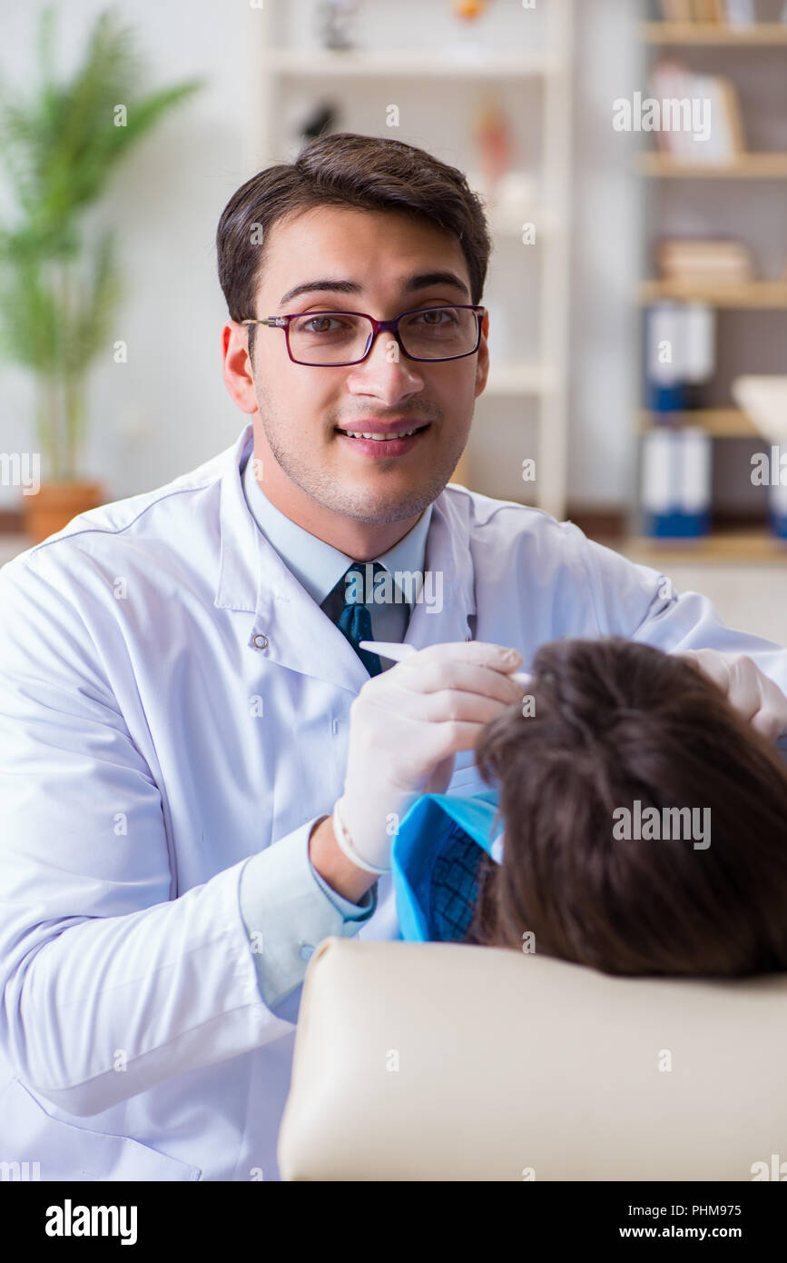 Patient visiting dentist for regular check-up and filling Stock Photo ...