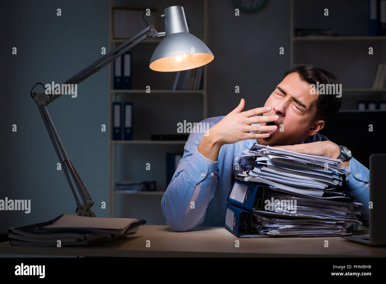 Employee working late at night at important report Stock Photo - Alamy