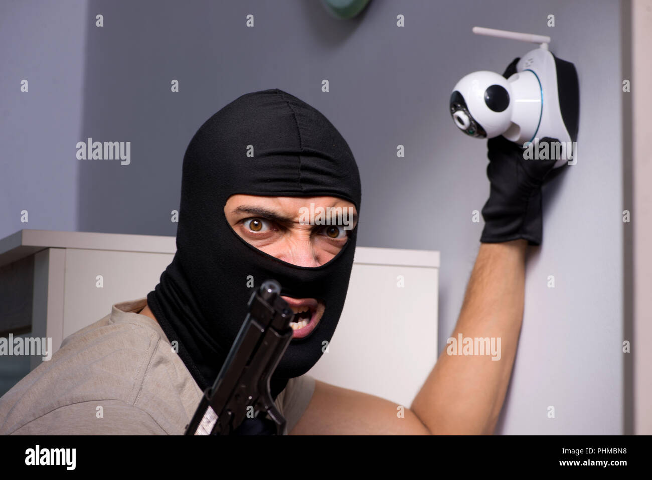 Burglar wearing balaclava mask at crime scene Stock Photo - Alamy