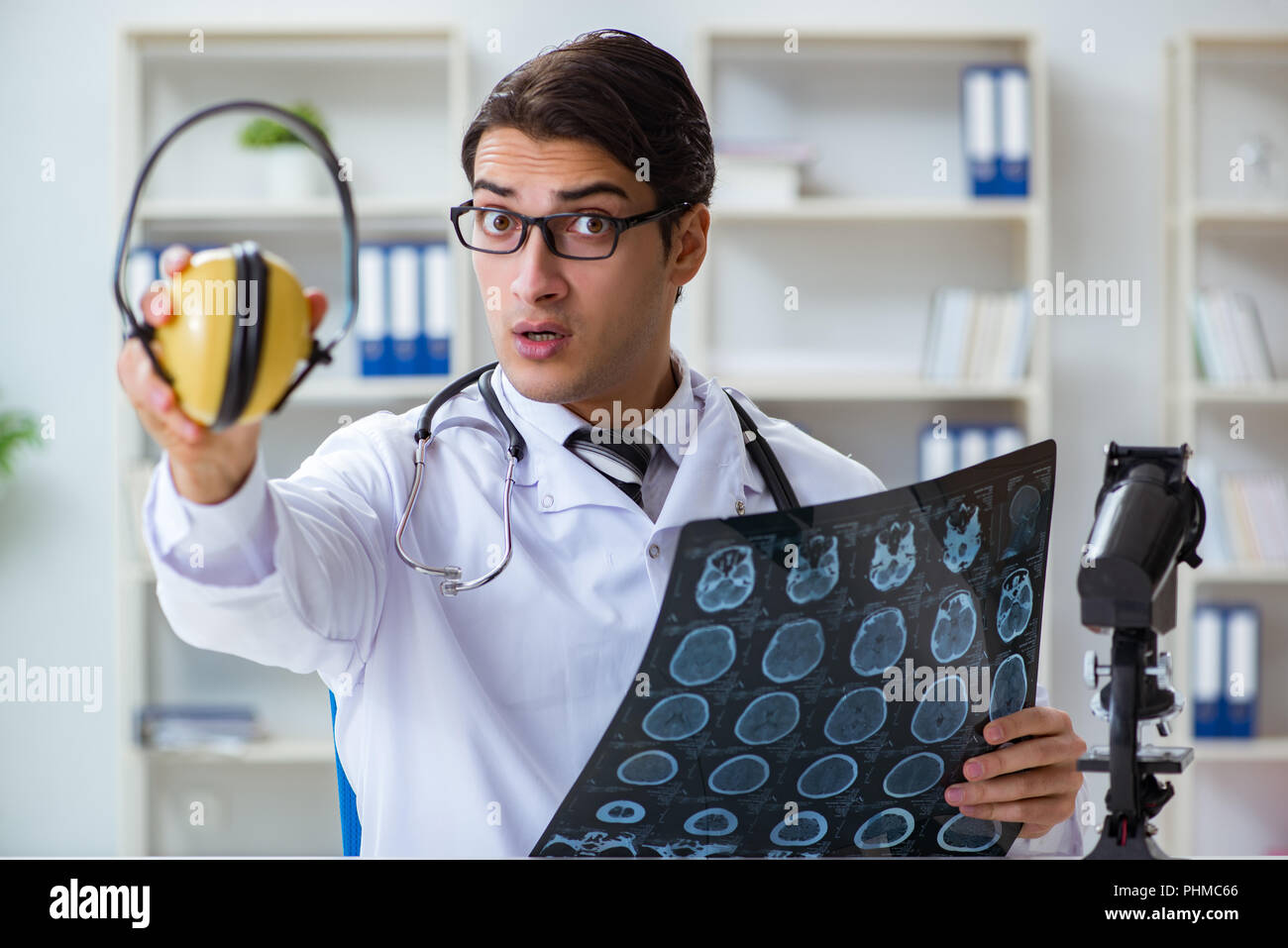 Safety doctor advising about noise cancelling headphones Stock Photo ...