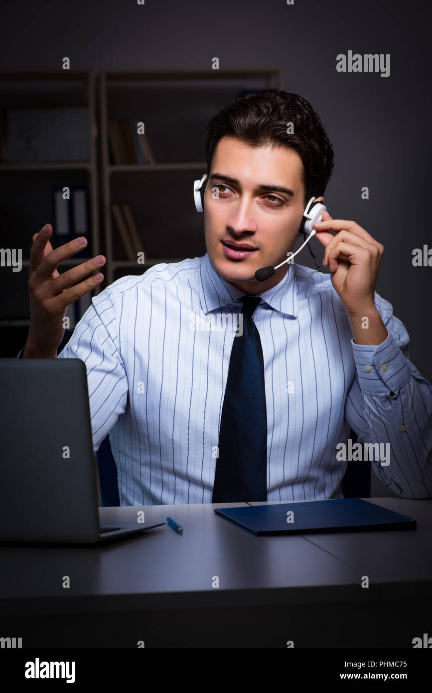 Call center operator talking to customer during night shift Stock Photo ...