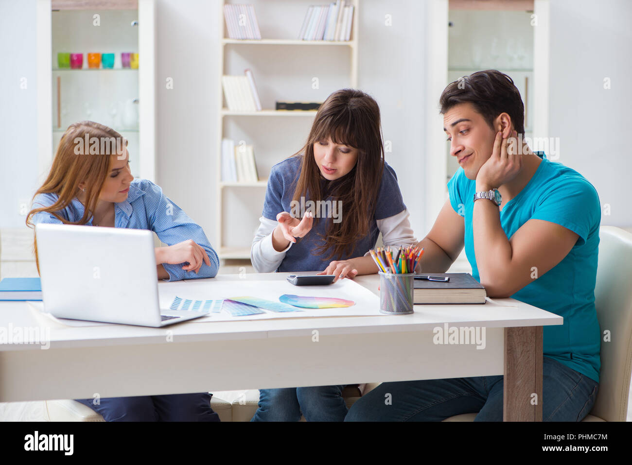 Team of designers discussing new interior project Stock Photo - Alamy