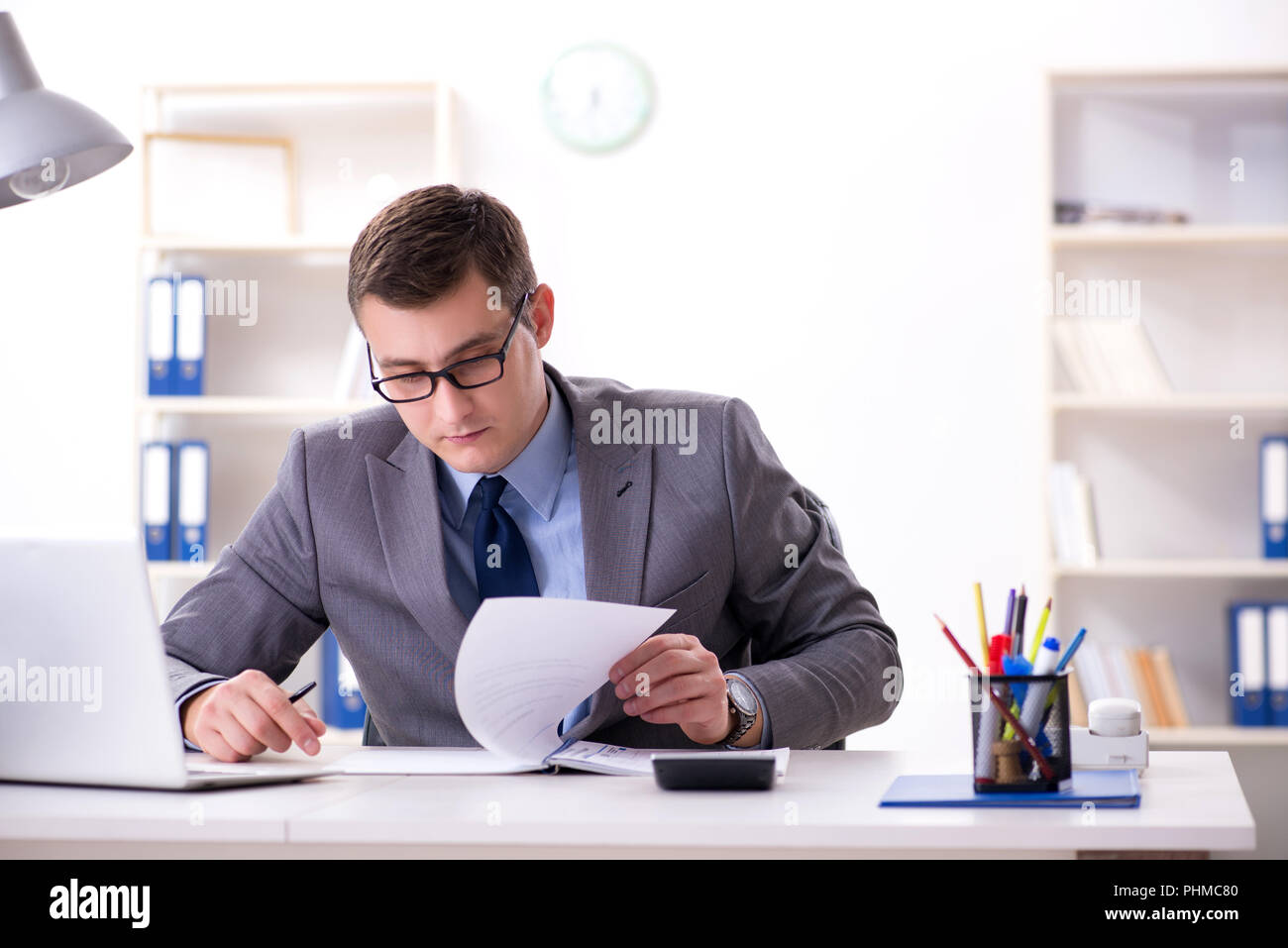Young handsome businessman employee working in office at desk Stock ...