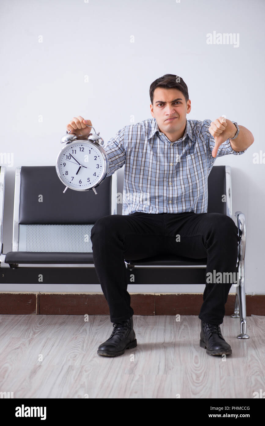 Man nervously impatiently waiting in the lobby Stock Photo - Alamy
