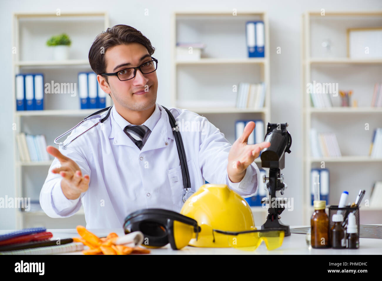 Safety doctor advising about wearing hard hat Stock Photo - Alamy